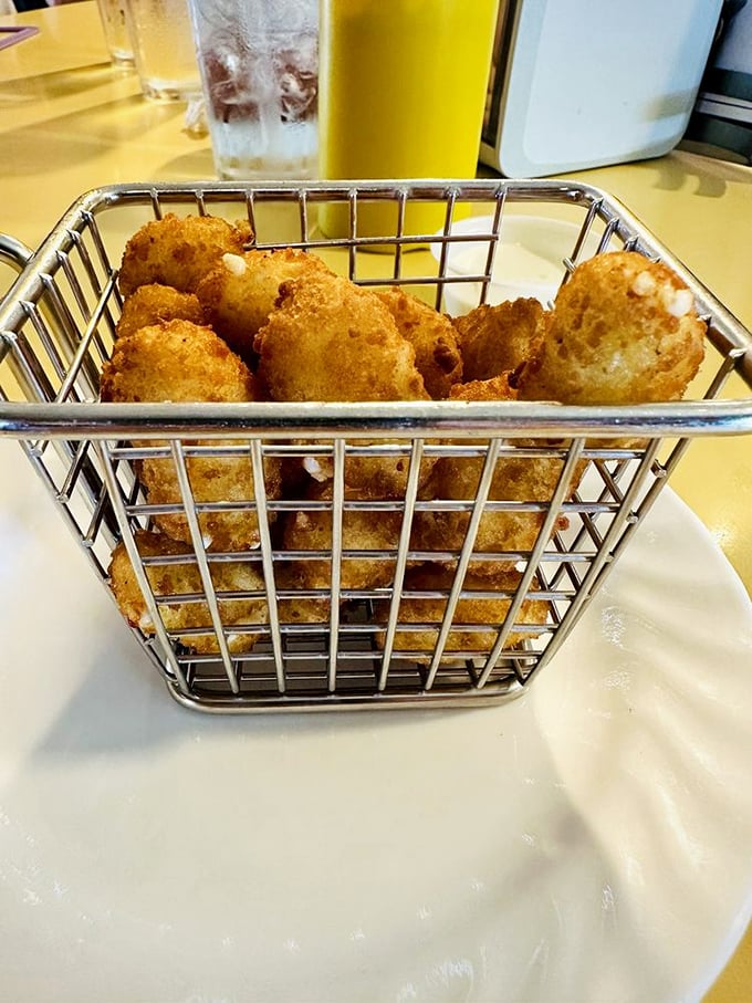 Wisconsin cheese curds: deep-fried nuggets of joy served in a miniature metal basket. Dairy this good deserves its own little throne.