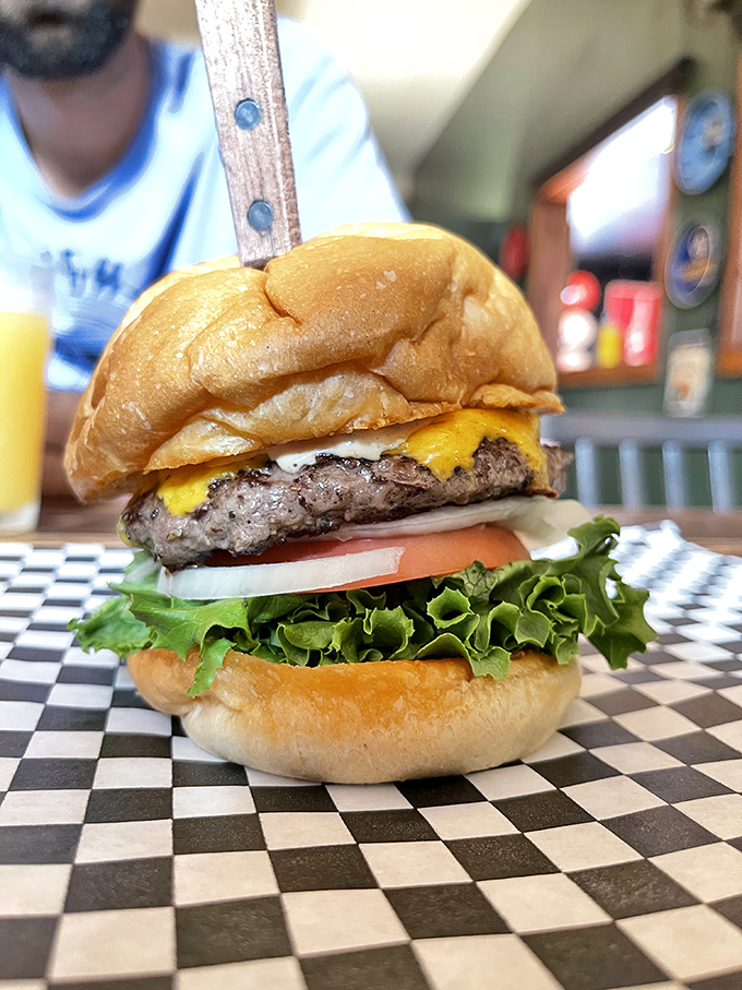 Behold the architecture of joy: perfectly stacked layers of beef, cheese, and fresh veggies on a toasted bun. This isn't fast food&mdash;it's slow happiness.