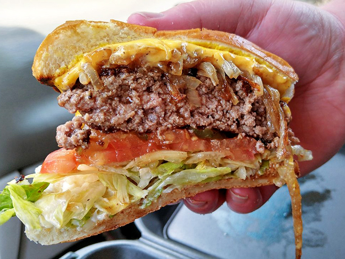 Cross-section of heaven. The perfect burger architecture reveals itself&mdash;juicy patty, melted cheese, fresh veggies, all in harmonious balance.