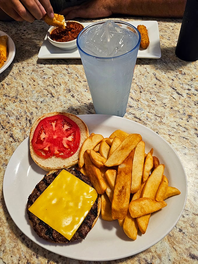 Sometimes happiness is as simple as a perfectly charred burger with melty cheese, a fresh tomato slice, and fries that look like they mean business.