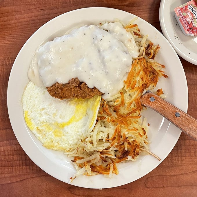 Country-fried steak smothered in gravy that could make a vegetarian question their life choices, with hashbrowns crisped to golden perfection.