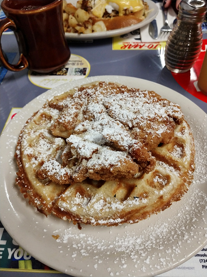 Golden waffle perfection dusted with powdered sugar. The breakfast gods are definitely smiling down on this plate.