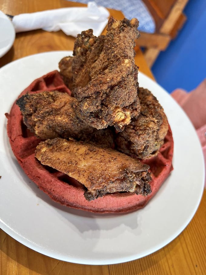 Red velvet waffle meets perfectly seasoned chicken&mdash;a marriage of flavors that would make even breakfast skeptics set early alarms.