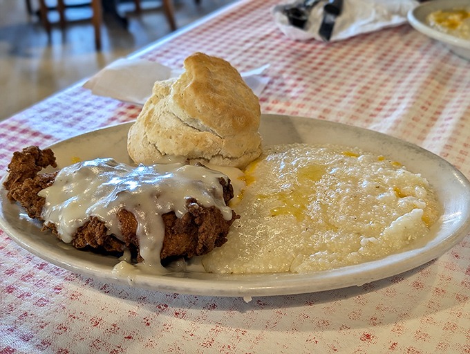The legendary chicken fried steak with its creamy gravy blanket, alongside grits so buttery they're practically formal wear for your breakfast.