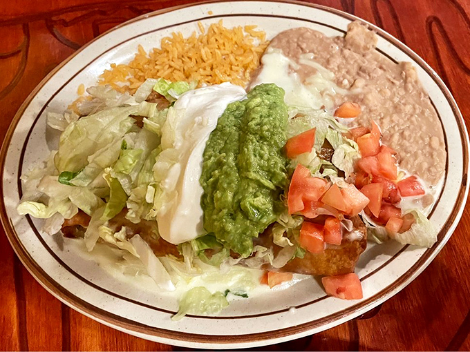 A chimichanga plate that makes you question why you ever ordered anything else. That vibrant guacamole is nature's perfect condiment.