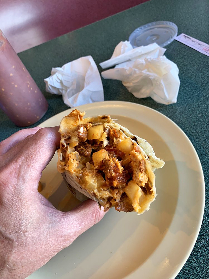 That sandwich in the background is merely a spectator to the real star &ndash; a burrito so gloriously smothered it requires strategic planning before the first bite.