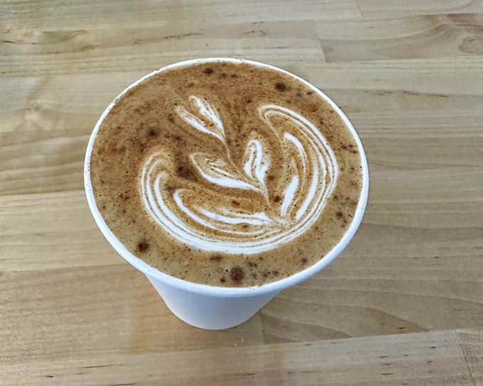 This isn't just latte art; it's a caffeinated Picasso. The delicate leaf pattern floating atop this cinnamon-spiced creation promises warmth in both temperature and spirit.