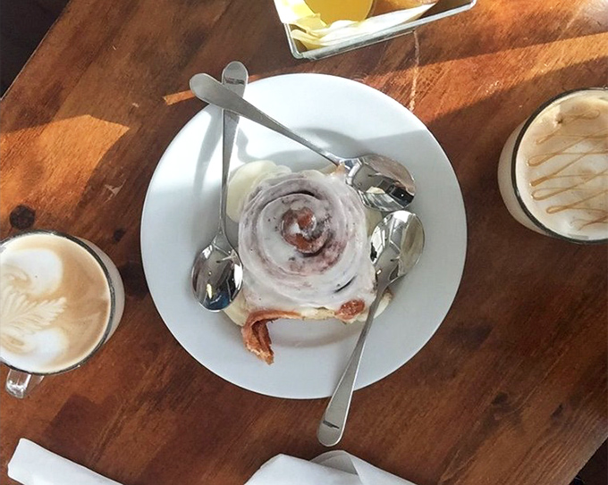 The cinnamon roll that launched a thousand diet cheat days, sitting innocently on its plate like it doesn't know what it's about to do to your willpower.