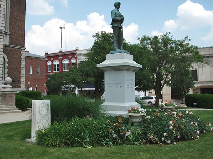 This Civil War memorial stands as a dignified reminder of sacrifice, surrounded by carefully tended gardens that add color to solemn remembrance.
