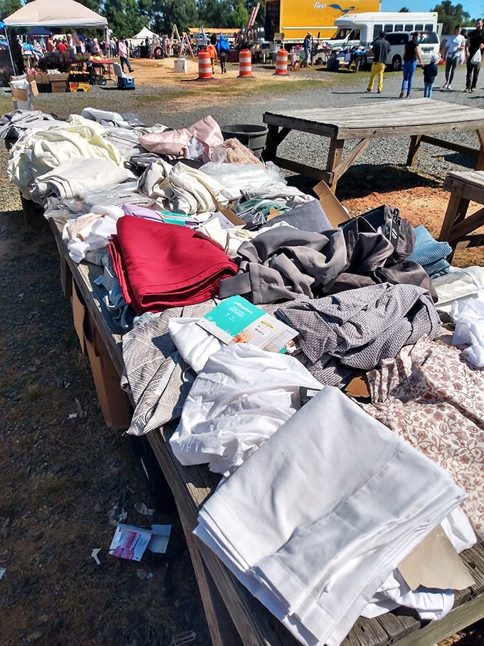 Textile treasure trove! Fabrics and linens spill across tables like an indoor yard sale where patience rewards the persistent bargain hunter.
