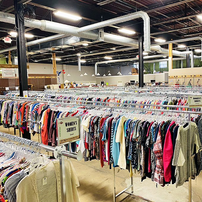 Clothing racks stretch toward the horizon like a textile sea. Organized by type and size for easy navigation through fashion's second chances.