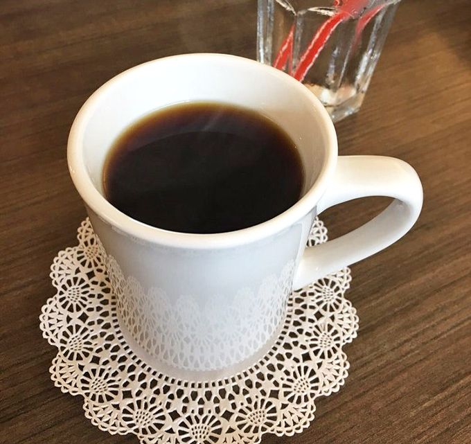 Simple pleasures: strong coffee served on a delicate doily. No fancy pour-overs or barista theatrics&mdash;just honest caffeine that knows its job.