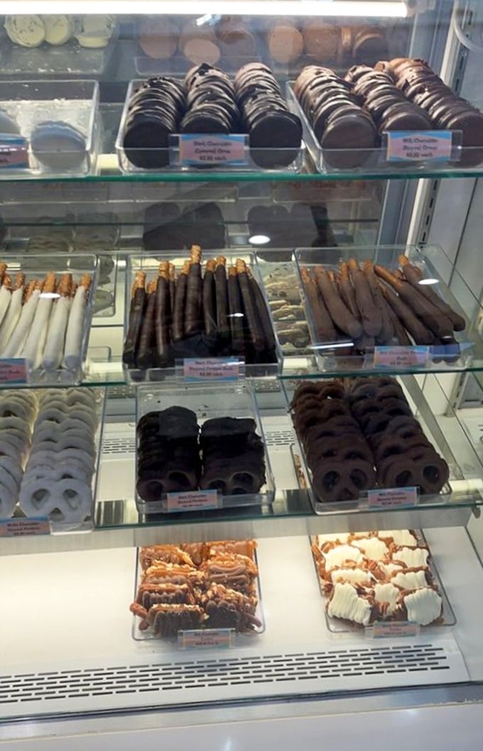Chocolate-dipped pretzels and cookies stand at attention behind glass, the sweet-salty diplomats of the dessert world.