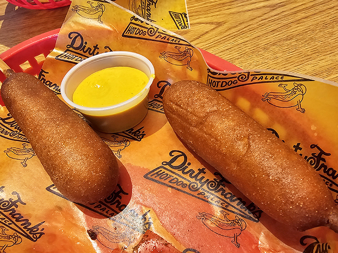 Corn dogs elevated to royalty status&mdash;crispy, golden sheaths protecting juicy dogs within, served with liquid sunshine for dipping.
