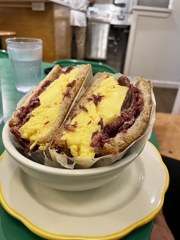 Breakfast sandwich nirvana achieved! Fluffy scrambled eggs meet savory corned beef in a handheld masterpiece that makes morning meetings completely optional.