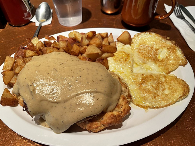 Gravity-defying biscuits smothered in country gravy alongside creamy grits topped with melted cheese. Cardiologists hate this plate, but your soul will thank you.