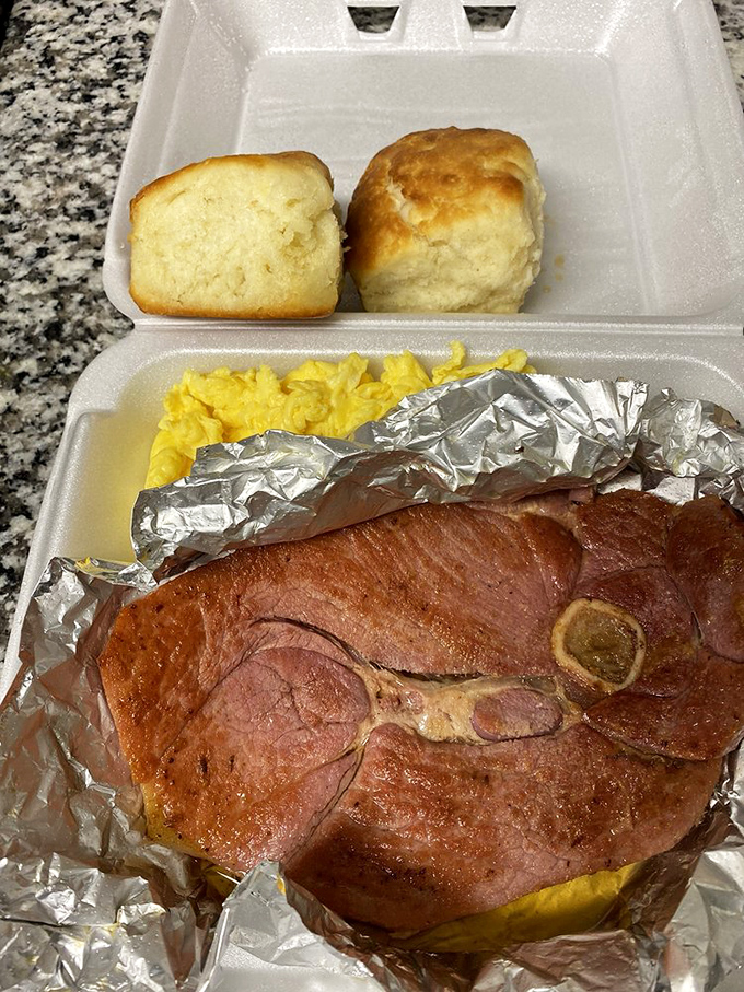 Country ham in its natural habitat, nestled beside fluffy eggs and those legendary biscuits. This is Tennessee's version of the breakfast holy trinity.