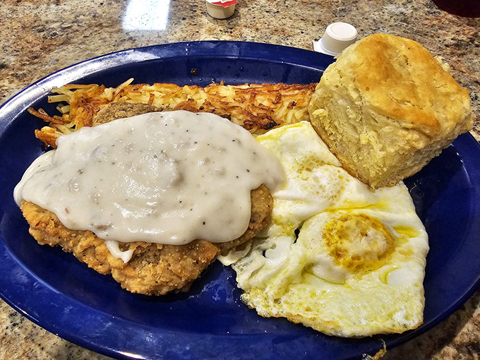 The legendary country fried steak in all its glory&mdash;crispy, tender, and smothered in gravy that would make your cardiologist wince and your soul sing. 
