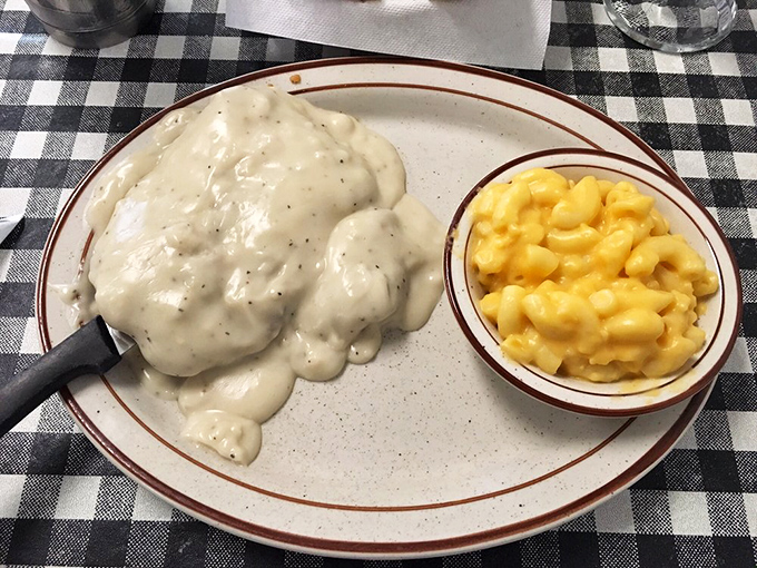 Country fried steak swimming in gravy that could solve international conflicts. The mac and cheese side isn't optional&mdash;it's essential to the complete experience.