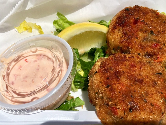Golden-fried crab cakes with that perfect crust, served with a side of pink sauce that whispers, "You made the right choice today."