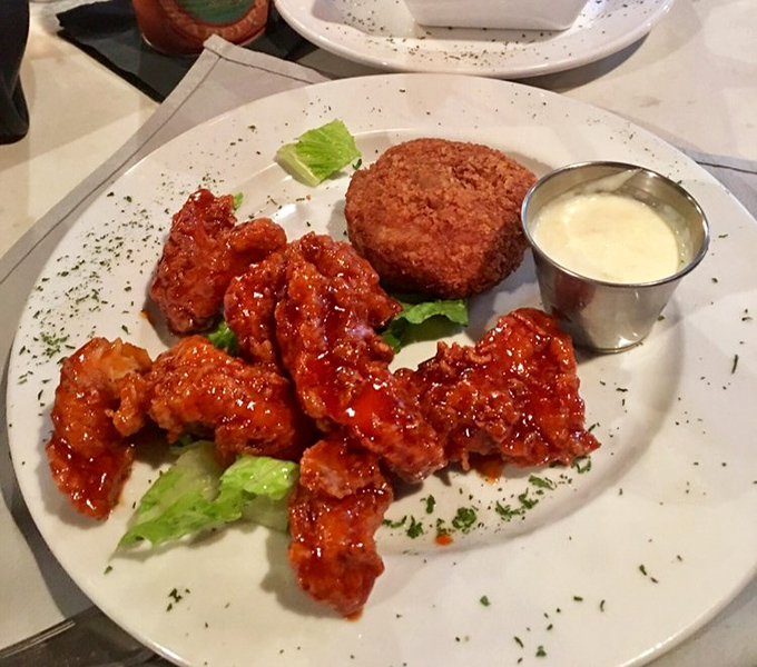 Sweet meets heat in this plate of honey sriracha chicken alongside a crab cake. A land-and-sea alliance that works better than most political ones.