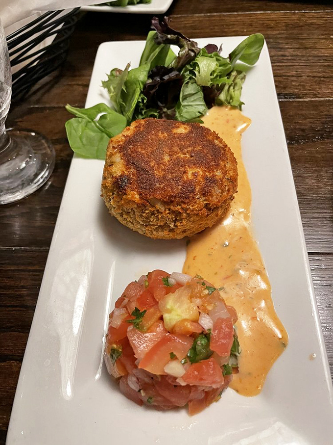 The perfect crab cake doesn't exi&mdash; wait, it does! Crispy exterior, tender interior, and a bright tomato salsa that sings of summer.