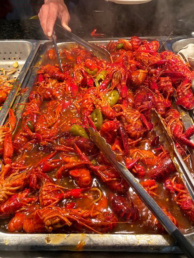 A sea of crimson crawfish swimming in savory sauce &ndash; proof that sometimes the messiest foods are the most satisfying. Keep those napkins handy!