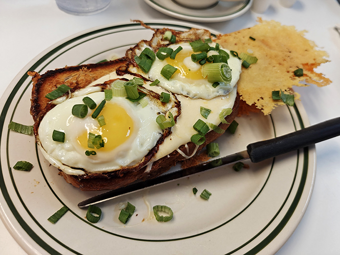 Eggs on toast: simple everywhere else, transformative at Louie's. Those perfectly runny yolks are nature's best sauce for that crispy parmesan crust.