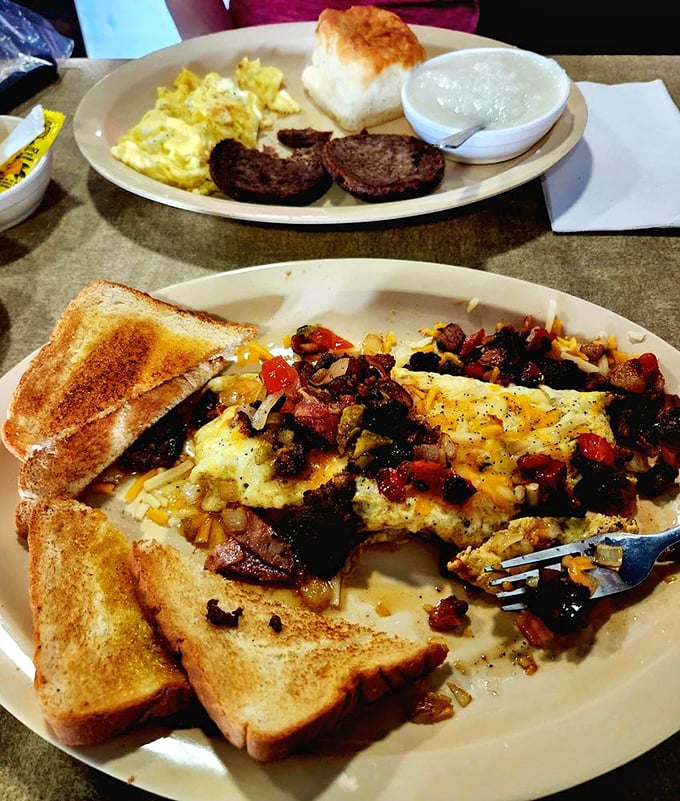 Breakfast done right: A hearty Denver omelet loaded with veggies and meat shares the table with buttery toast that's achieved golden perfection. 