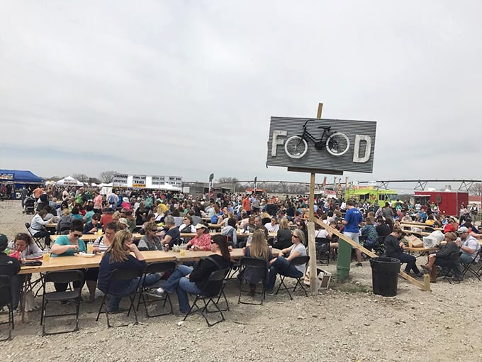Hungry shoppers recharge at communal tables under the clever "FOOD" sign, where a bicycle perches as if to say "you'll need energy for more shopping."
