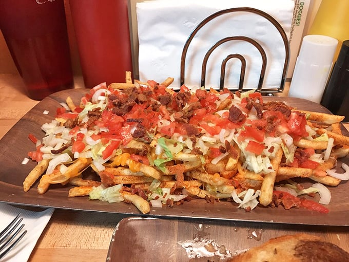 These loaded fries are what happens when a potato has ambition. Tomatoes, lettuce, and mystery toppings create a fork-required masterpiece.