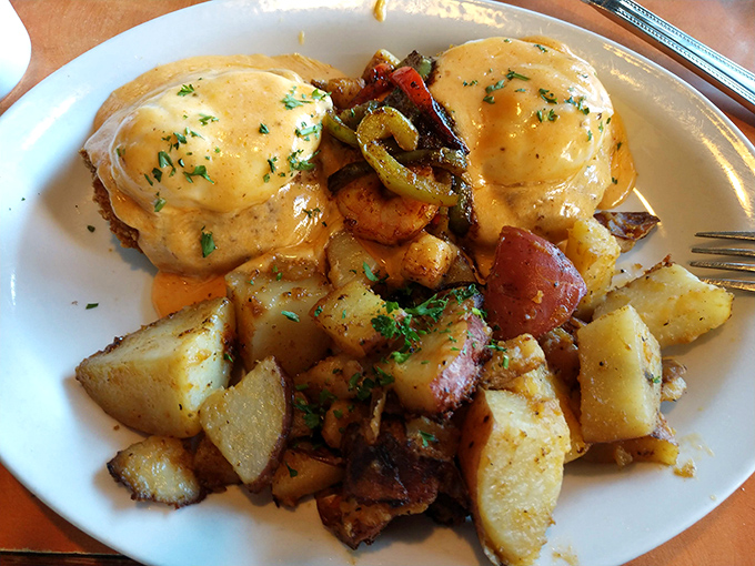 Benedict done right: perfectly poached eggs lounging on their throne of potatoes, draped in hollandaise that's practically liquid gold.