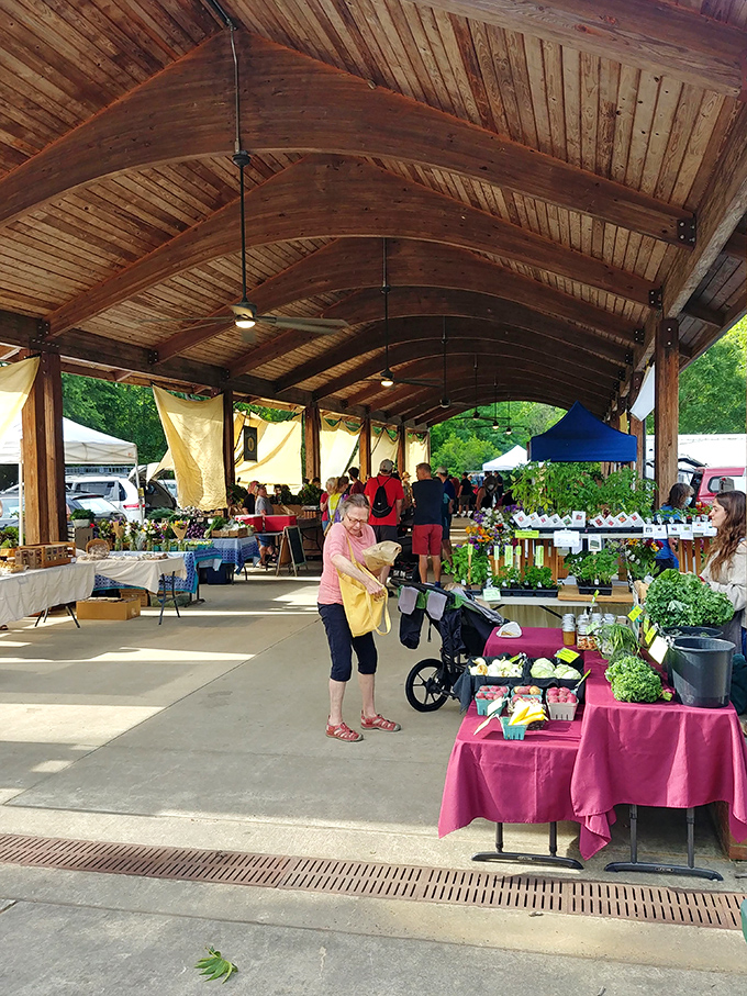Farmers market heaven! Local growers and artisans gather under wooden beams to offer everything from heirloom tomatoes to handcrafted soaps.