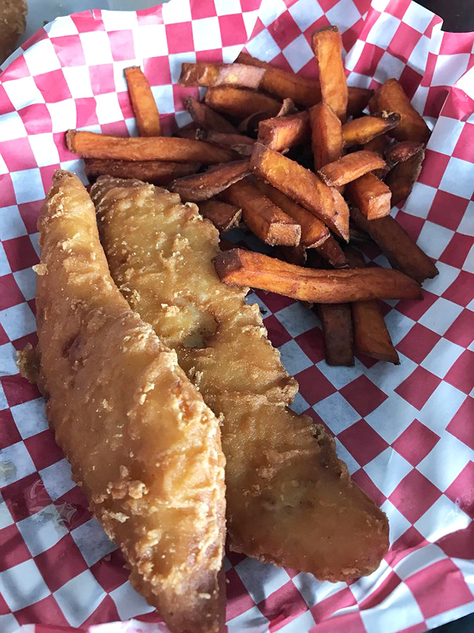 Golden-battered fish that shatters with each bite, alongside hand-cut fries. The checkered paper says "casual," but the flavor says "sophisticated."