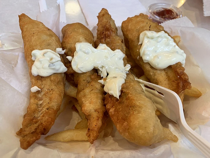 Golden-battered fish that shatters with each bite, topped with tartar sauce that doesn't come from a packet. This is seafood respect.