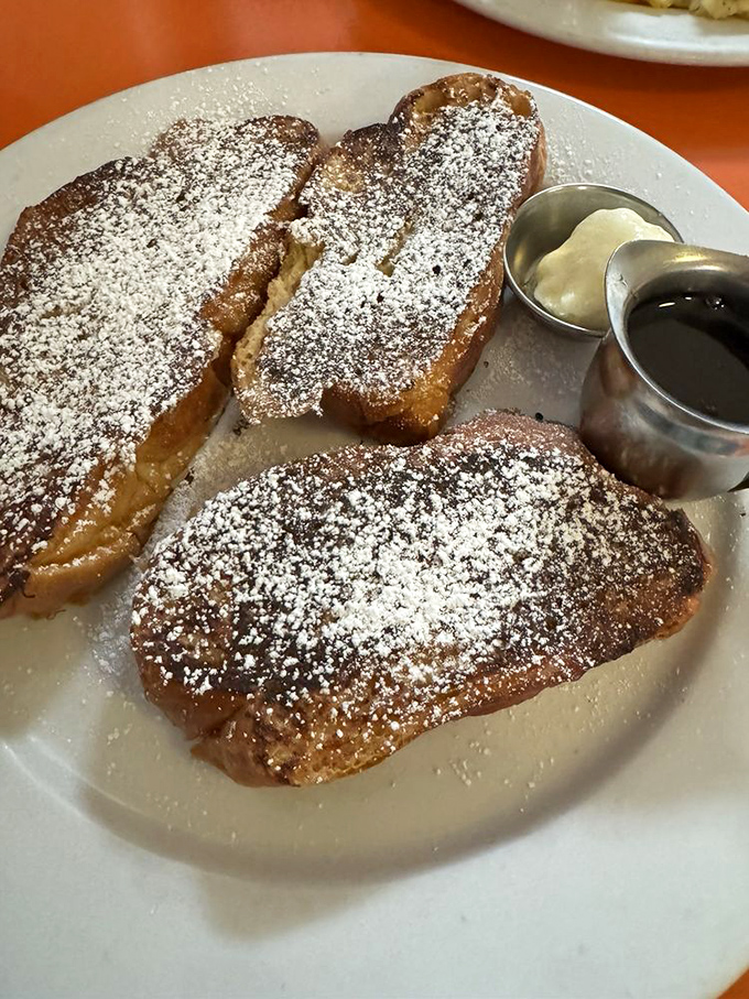 French toast that's achieved the golden-brown perfection many attempt but few master. That powdered sugar dusting isn't decoration—it's ceremony.