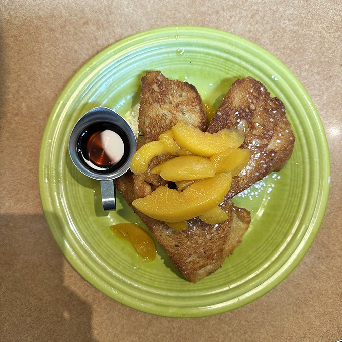 French toast that's crossed the border into dessert territory, topped with fruit that makes you feel virtuous about your decadent choices.
