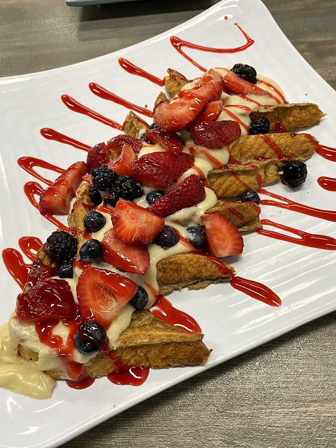 French toast elevated to art form&mdash;custard-soaked bread adorned with berries and cream drizzles that would make even breakfast skeptics weak at the knees.