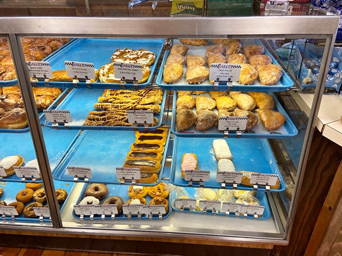 The display case reveals layers of pastry treasures, each tray a different chapter in the story of "Why Your Diet Starts Tomorrow."