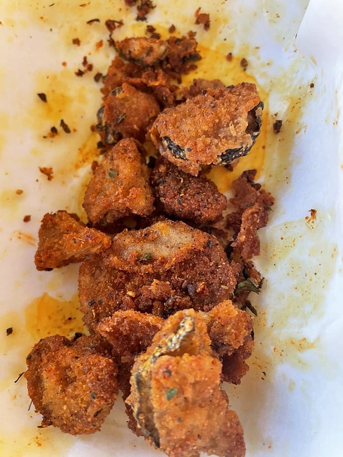 These aren't just fried pickles&mdash;they're little golden discs of tangy, crunchy perfection that disappear faster than Wisconsin snow in April.