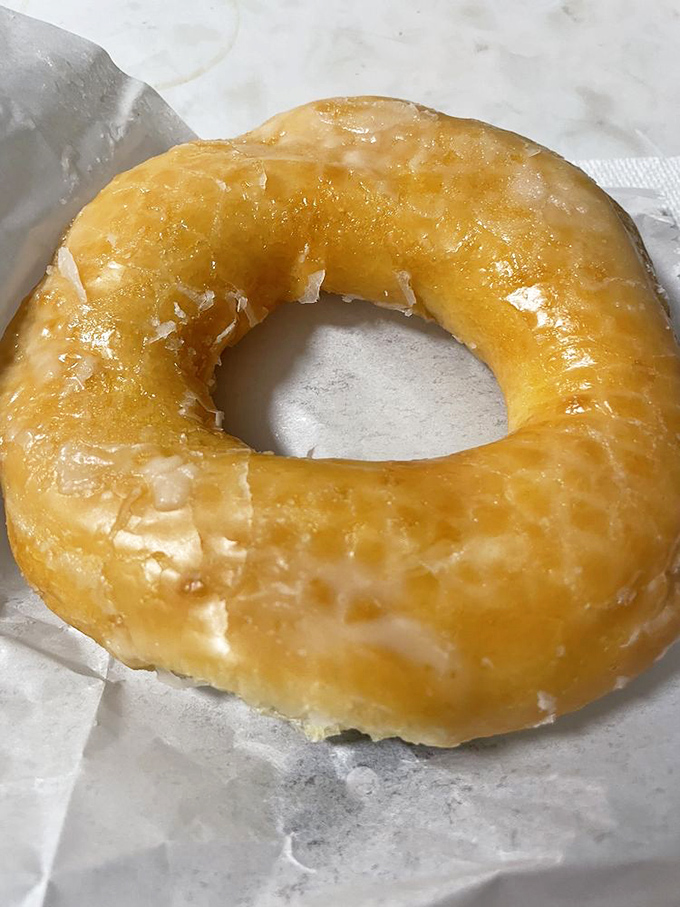 The humble glazed donut, perfected. This golden ring of happiness proves that sometimes the simplest pleasures are the most satisfying.