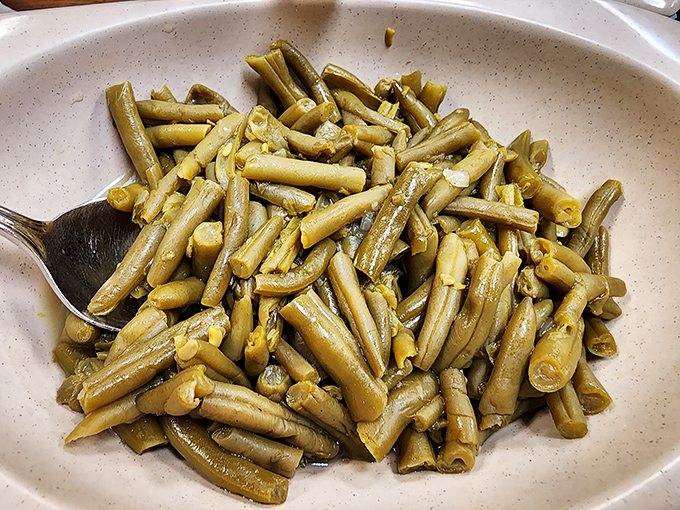 These aren't your fancy restaurant "al dente" green beans&mdash;these are proper Southern beans, cooked low and slow with bits of ham until they surrender all their goodness.