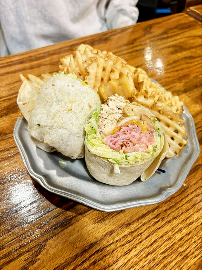 The wrap that launched a thousand cravings: fresh ingredients bundled together with those legendary waffle fries standing guard.
