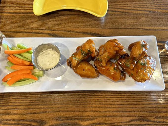 These aren't just wings; they're sticky-sweet flavor bombs with a kick, accompanied by the cooling crunch of fresh veggies&mdash;nature's fire extinguisher.