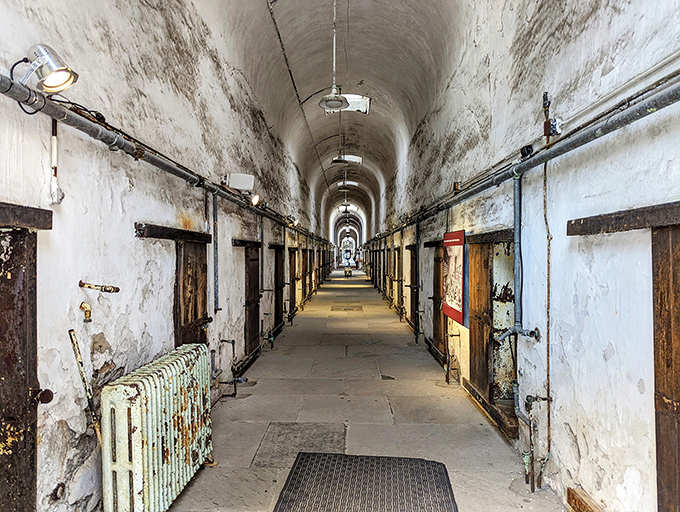 The infamous cellblock corridor stretches into infinity, doors open to the cells where men once contemplated their choices. Talk about a long walk home.