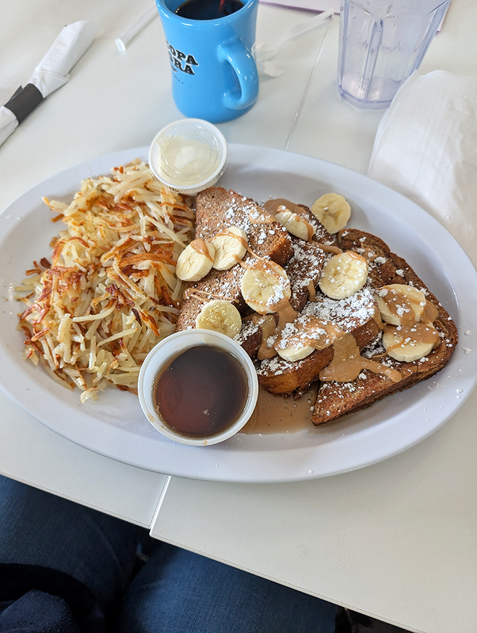 French toast with sliced bananas and crispy hash browns - proof that breakfast is the only meal worth setting an alarm for.