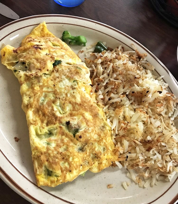 The dynamic duo of breakfast: a veggie-packed omelette alongside crispy, seasoned hashbrowns. Name a more iconic breakfast pairing—I'll wait.