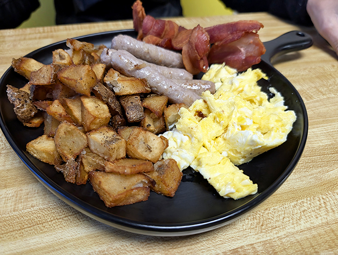 The breakfast trinity: perfectly seasoned home fries, eggs that know their purpose, and breakfast meats that had one job and nailed it.