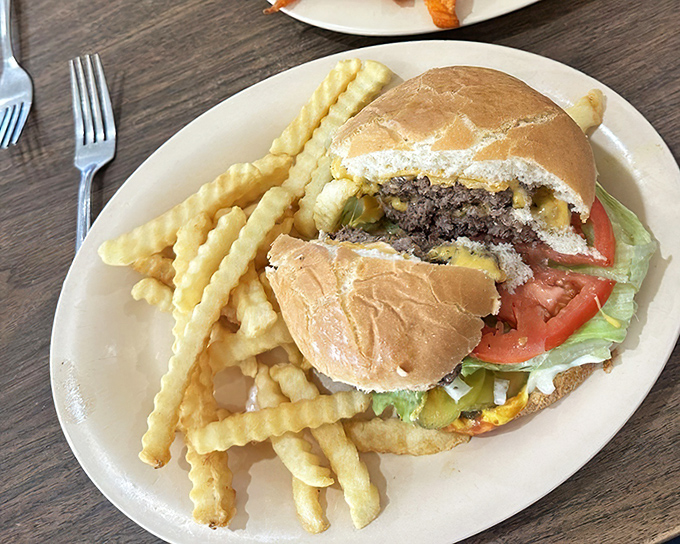 A burger that doesn't need Instagram filters or fancy aioli to make its point &ndash; just honest beef, fresh toppings, and those gloriously crispy crinkle fries.