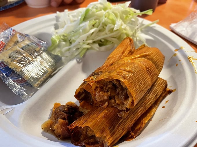 Delta tamales&mdash;corn husks unfurling to reveal spiced treasures within&mdash;served with a side of slaw that cuts through the richness perfectly.